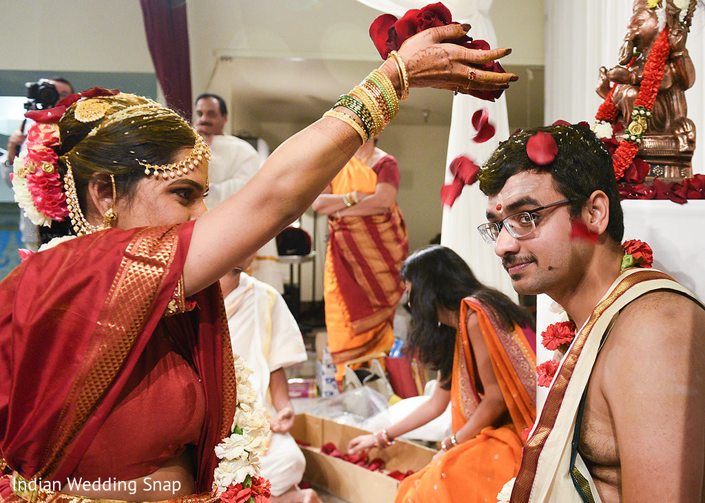 Indian bride showering flower petals to groom | Photo 115079