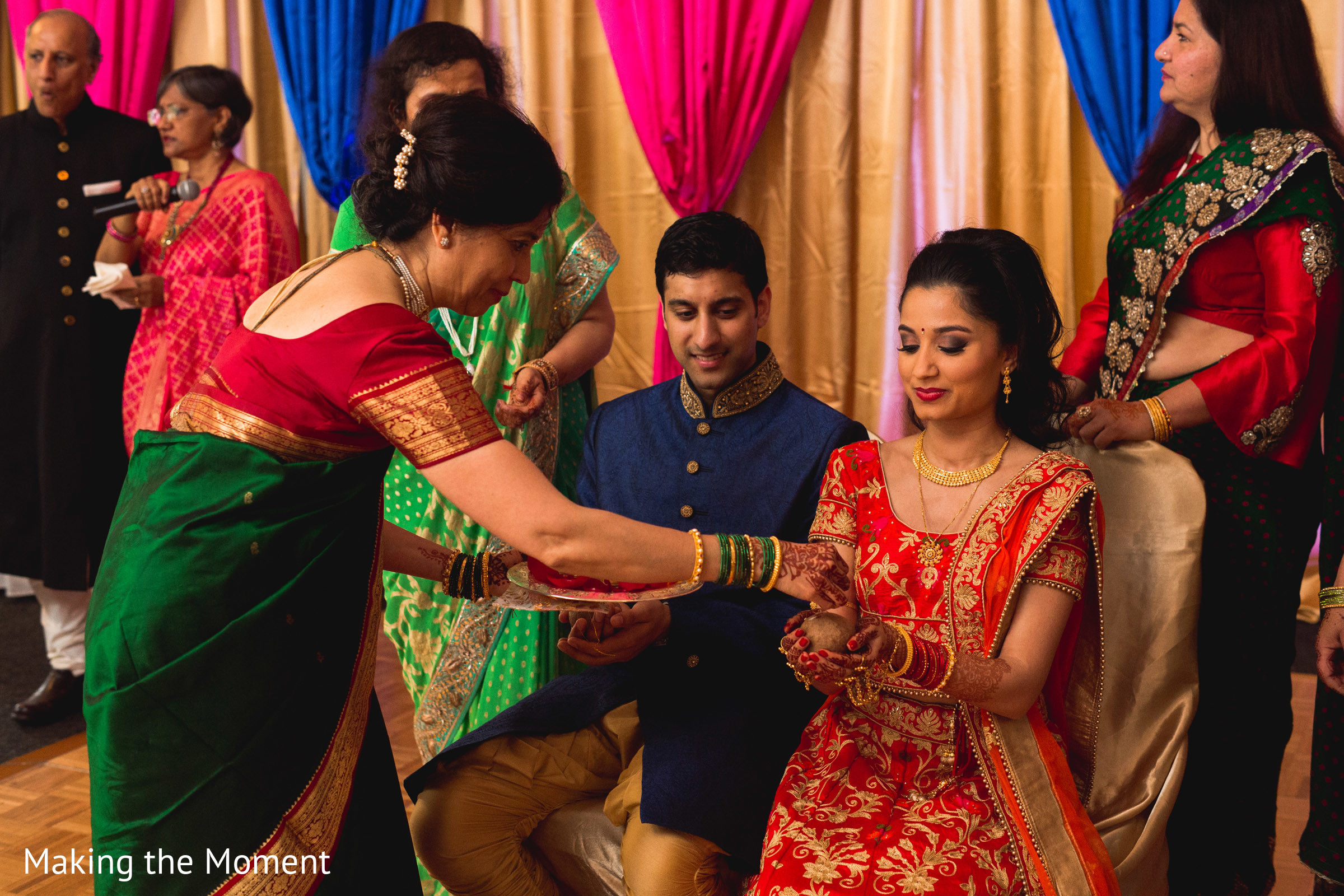 Indian bride holding a coconut during sangeet celebration. | Photo 170407
