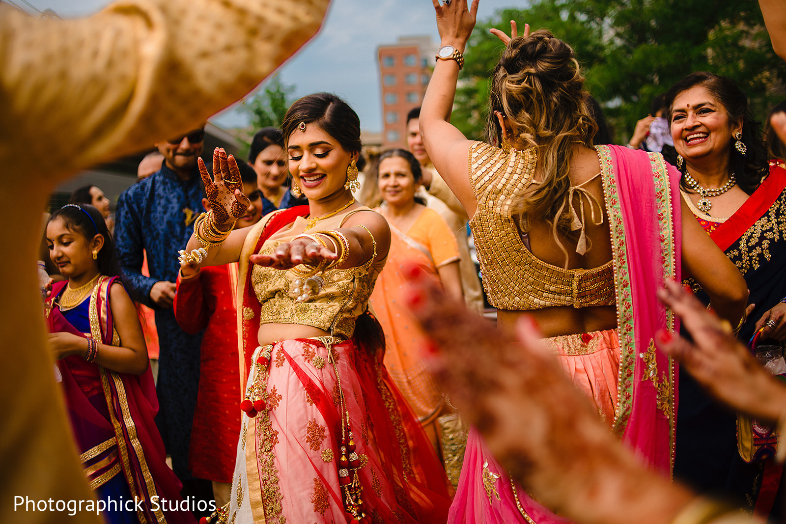 Indian bride and bridesmaids dancing at the baraat celebration. | Photo ...