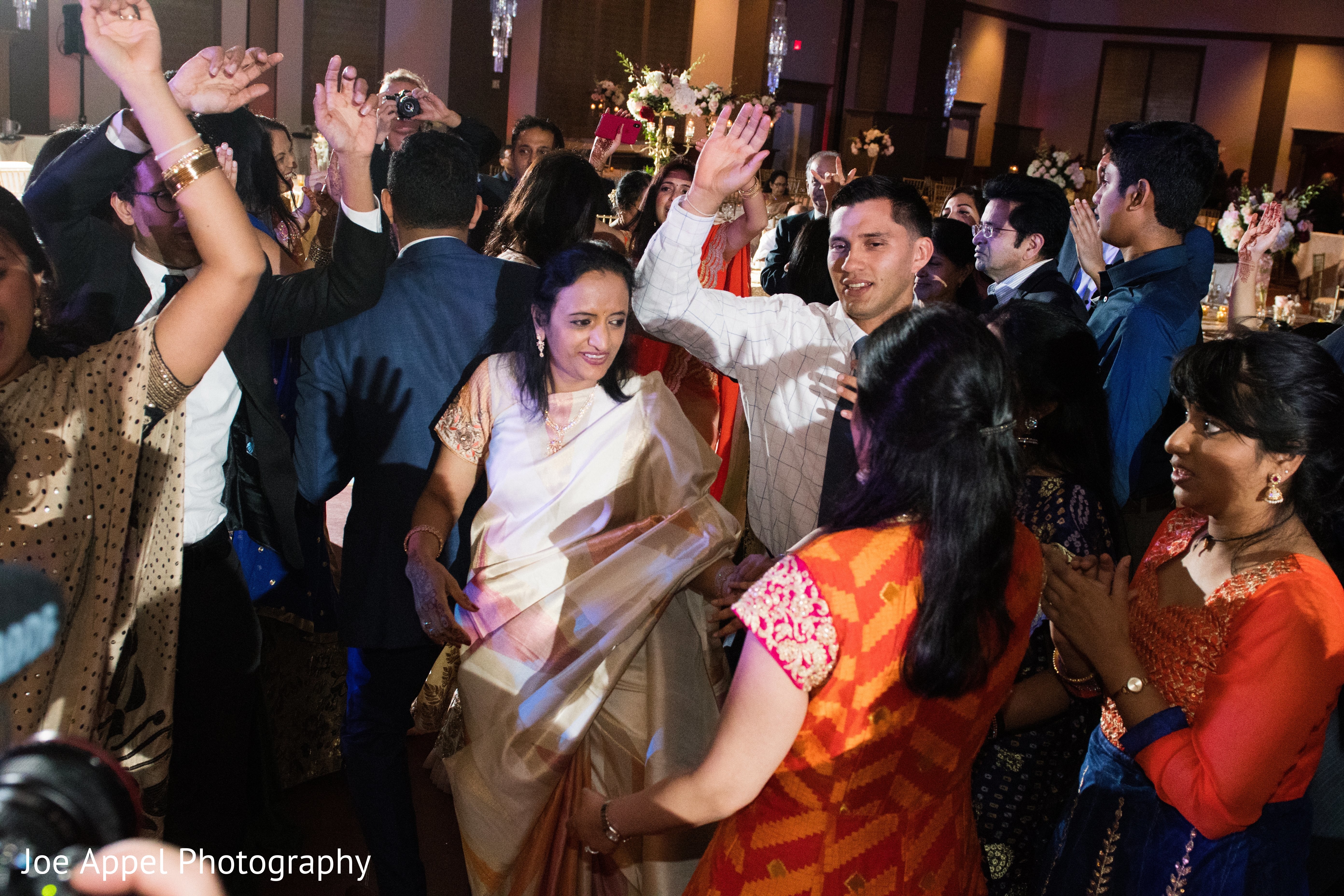 Indian wedding guests having a great time during the reception | Photo ...