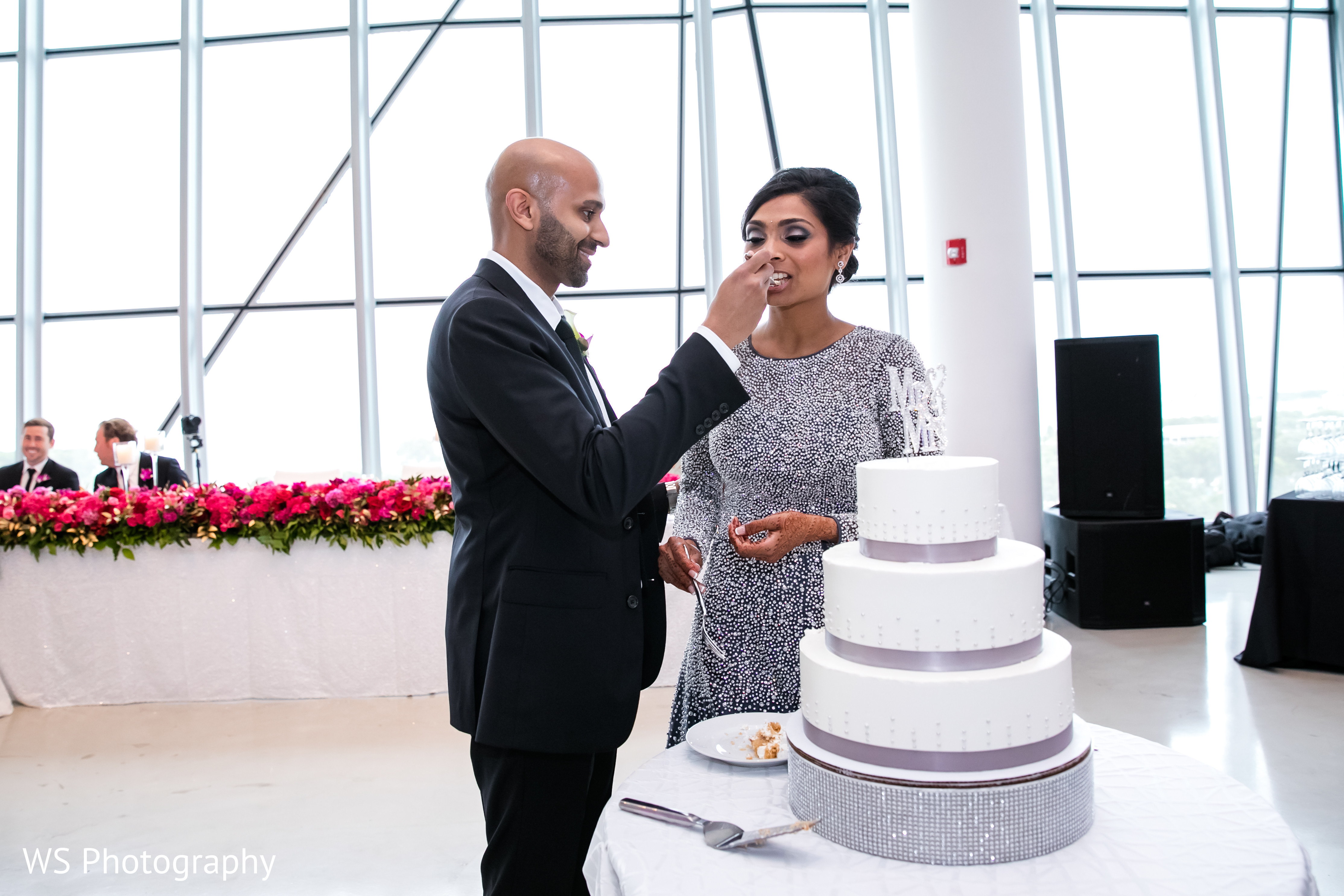 Lovely capture Indian groom giving cake to the bride. | Photo 194500
