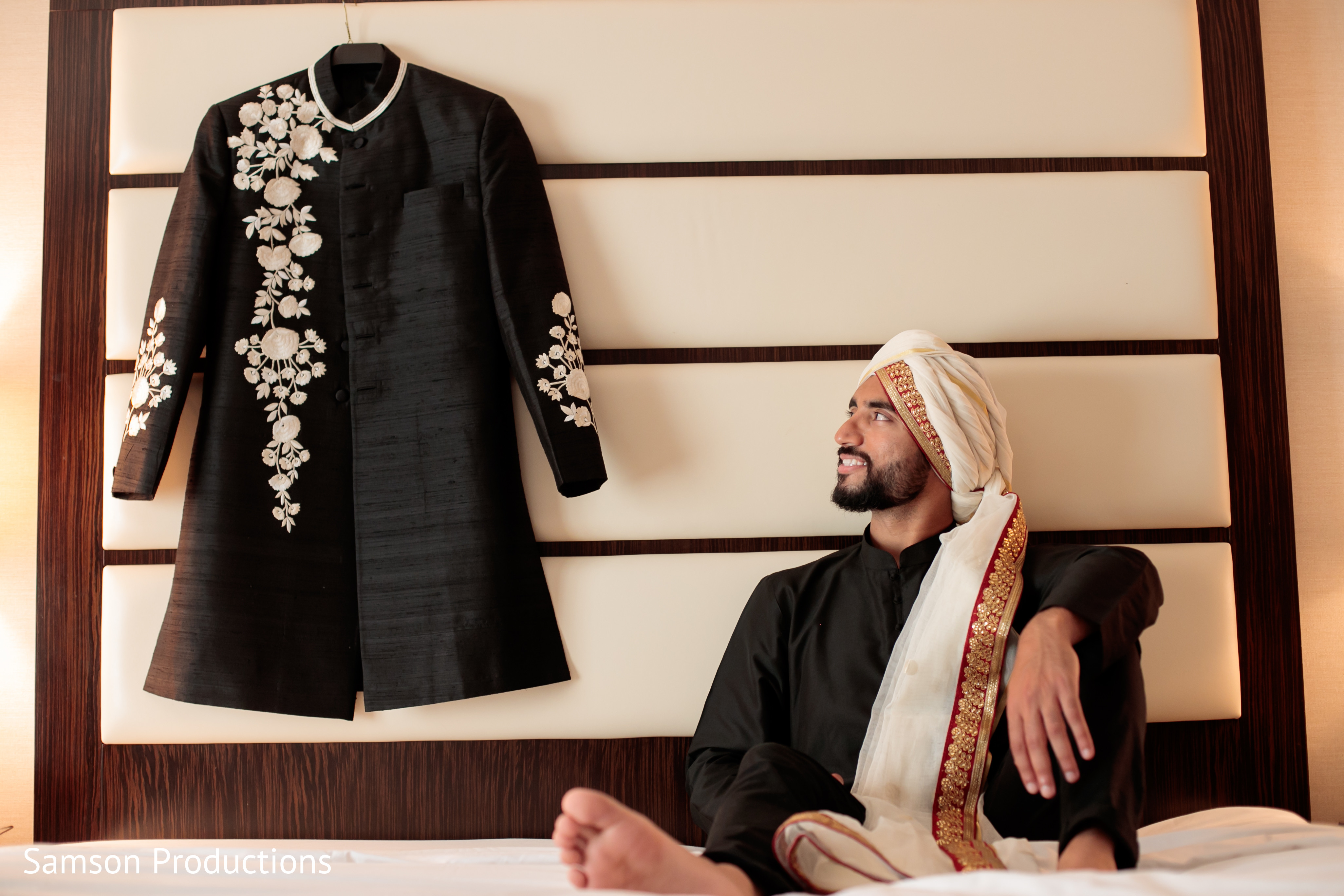 Indian groom staring at his sherwani for the wedding | Photo 195372