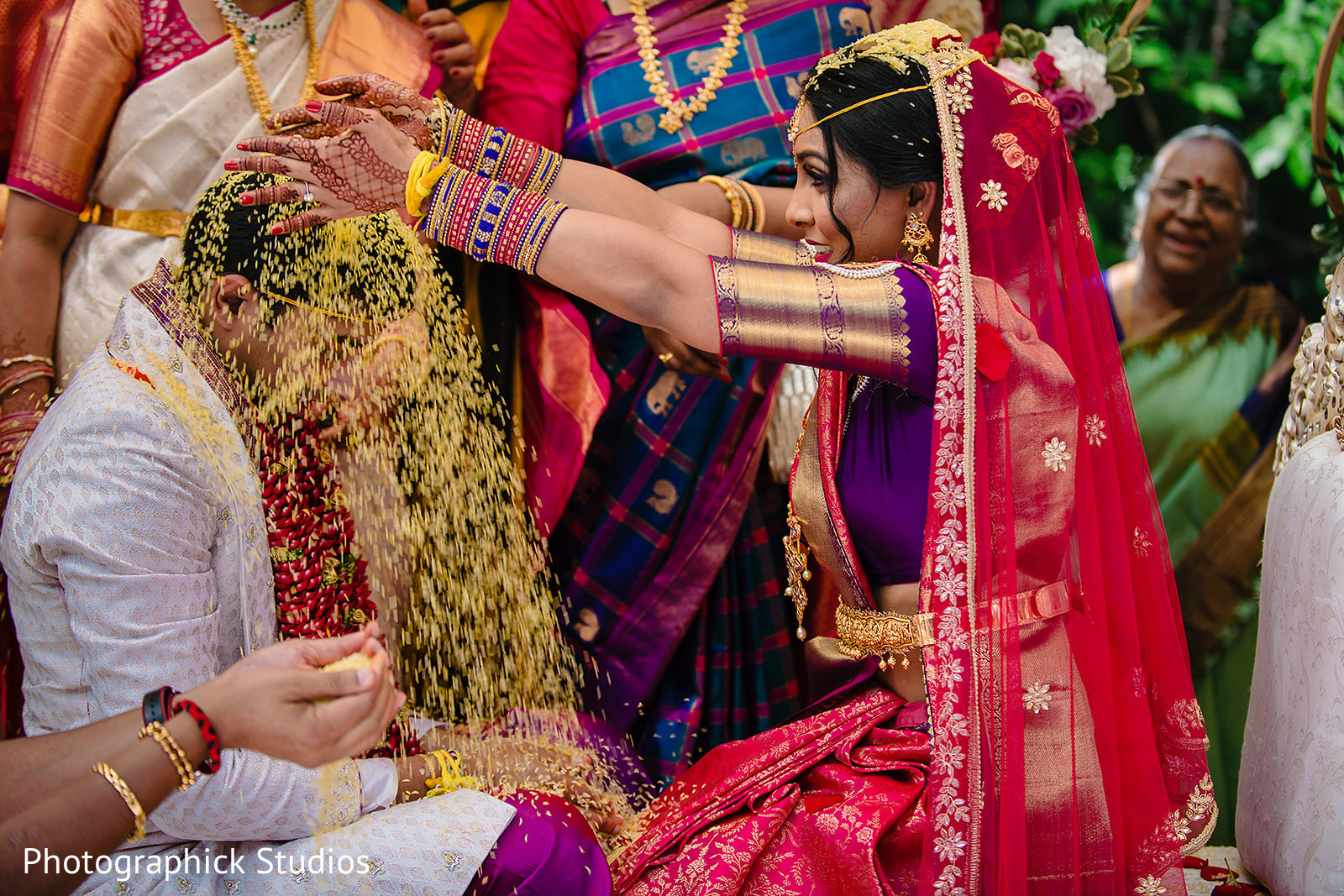 Indian bride pouring rice to groom. | Photo 199105