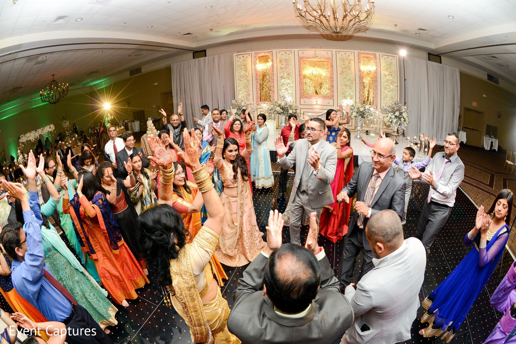 Indian bride and groom with wedding guests rocking the dance floor ...