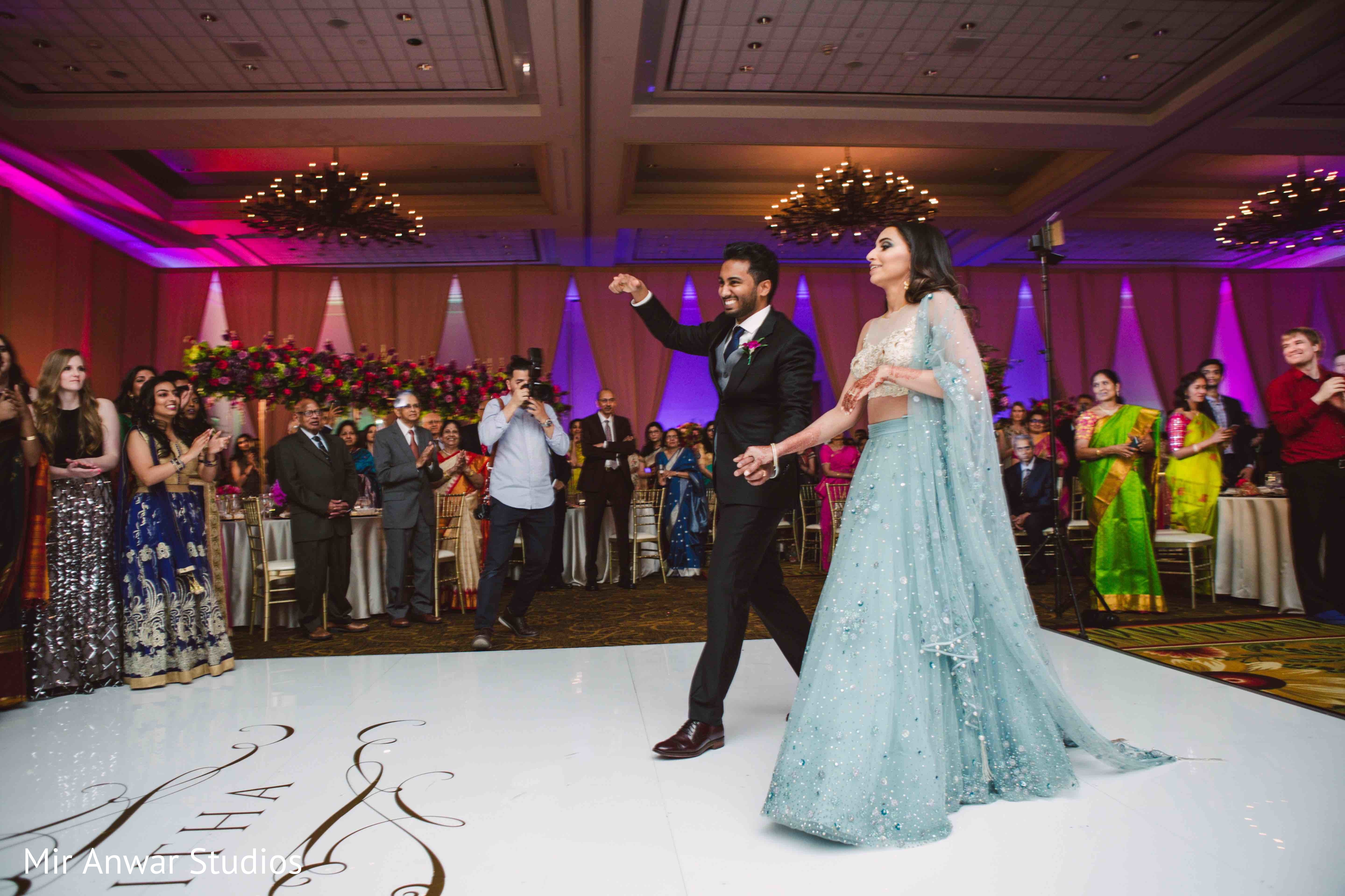 Joyful Indian couple entrance to wedding reception. | Photo 218580