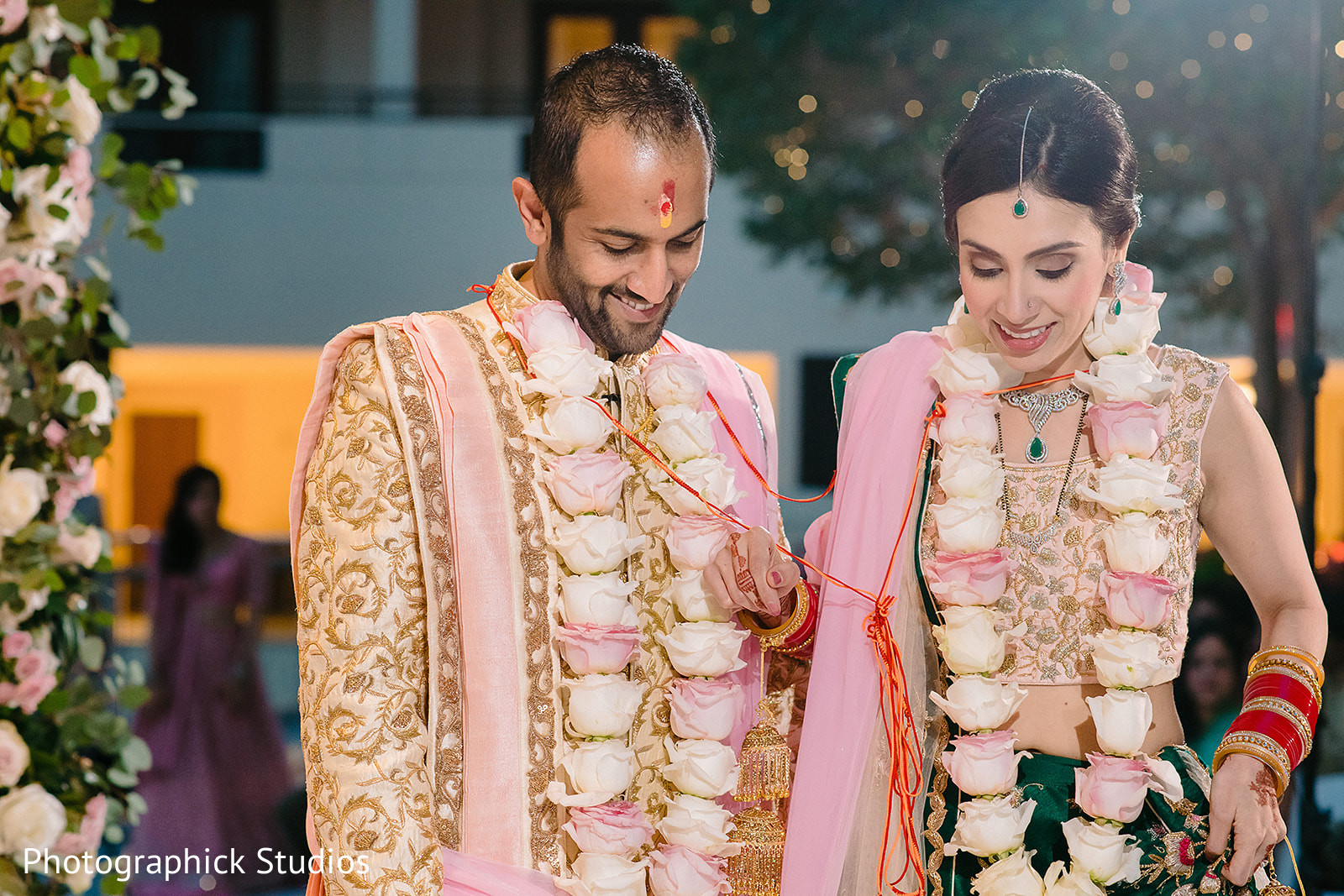 Indian bride and groom rolling betel nut with toes | Photo 219449