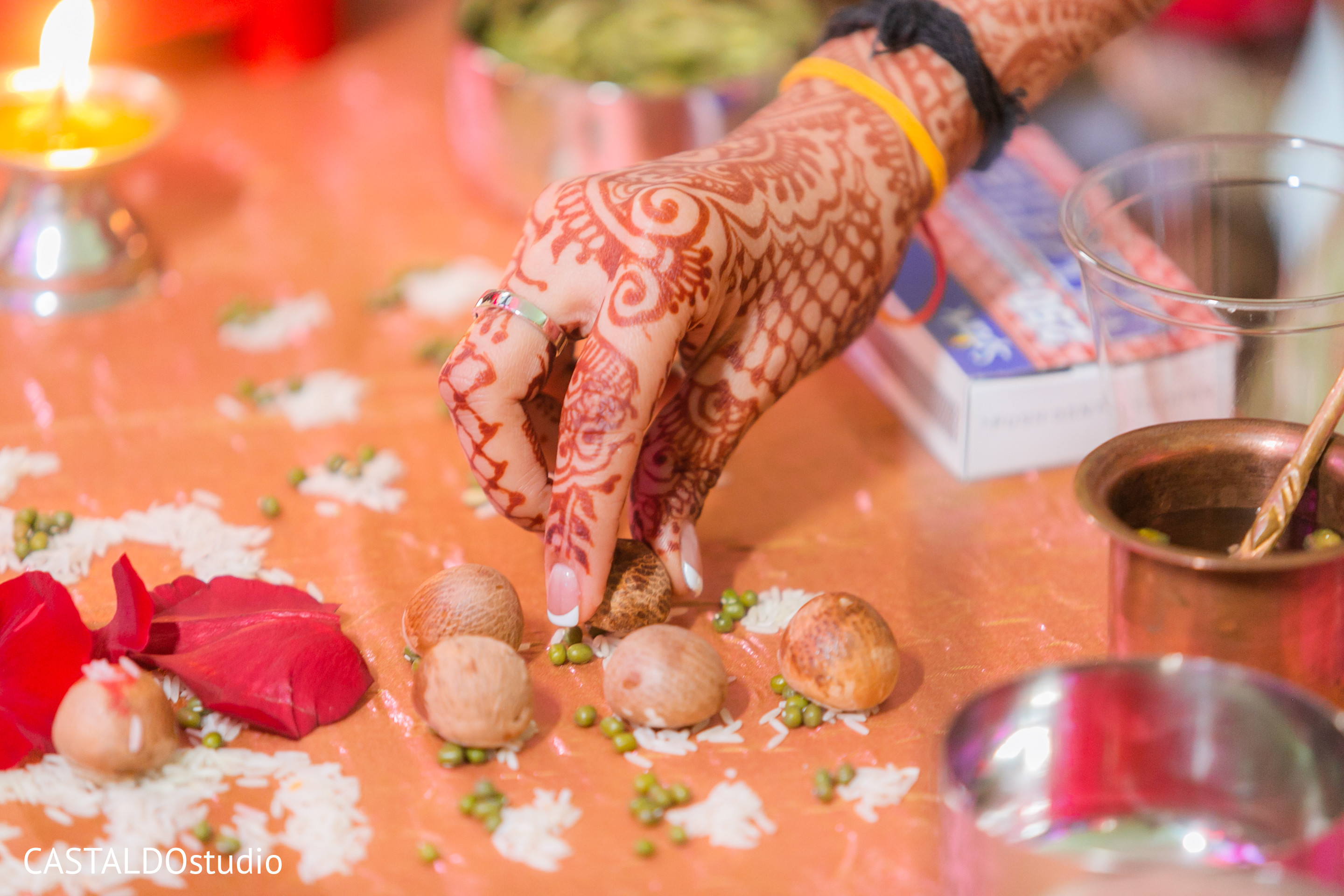 Indian bride grabbing a nut at ceremony ritual. | Photo 222648