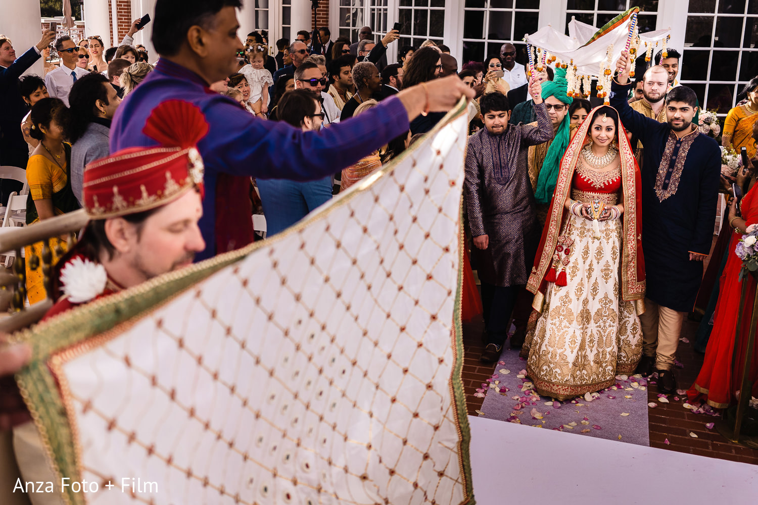Indian groom covered with antarpat at bridal entrance to ceremony ...