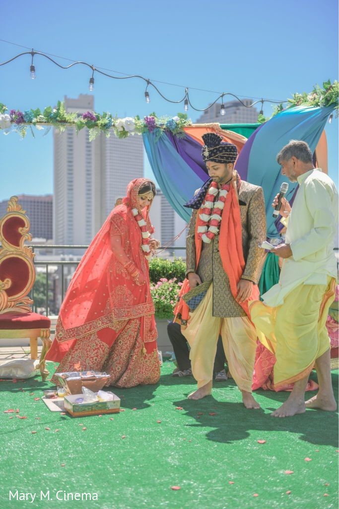 Indian bride and groom walking the seven steps around sacred fire ...
