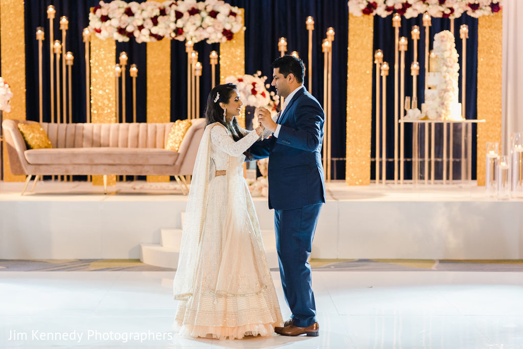 Indian bride with her Indian groom performing in the reception party ...