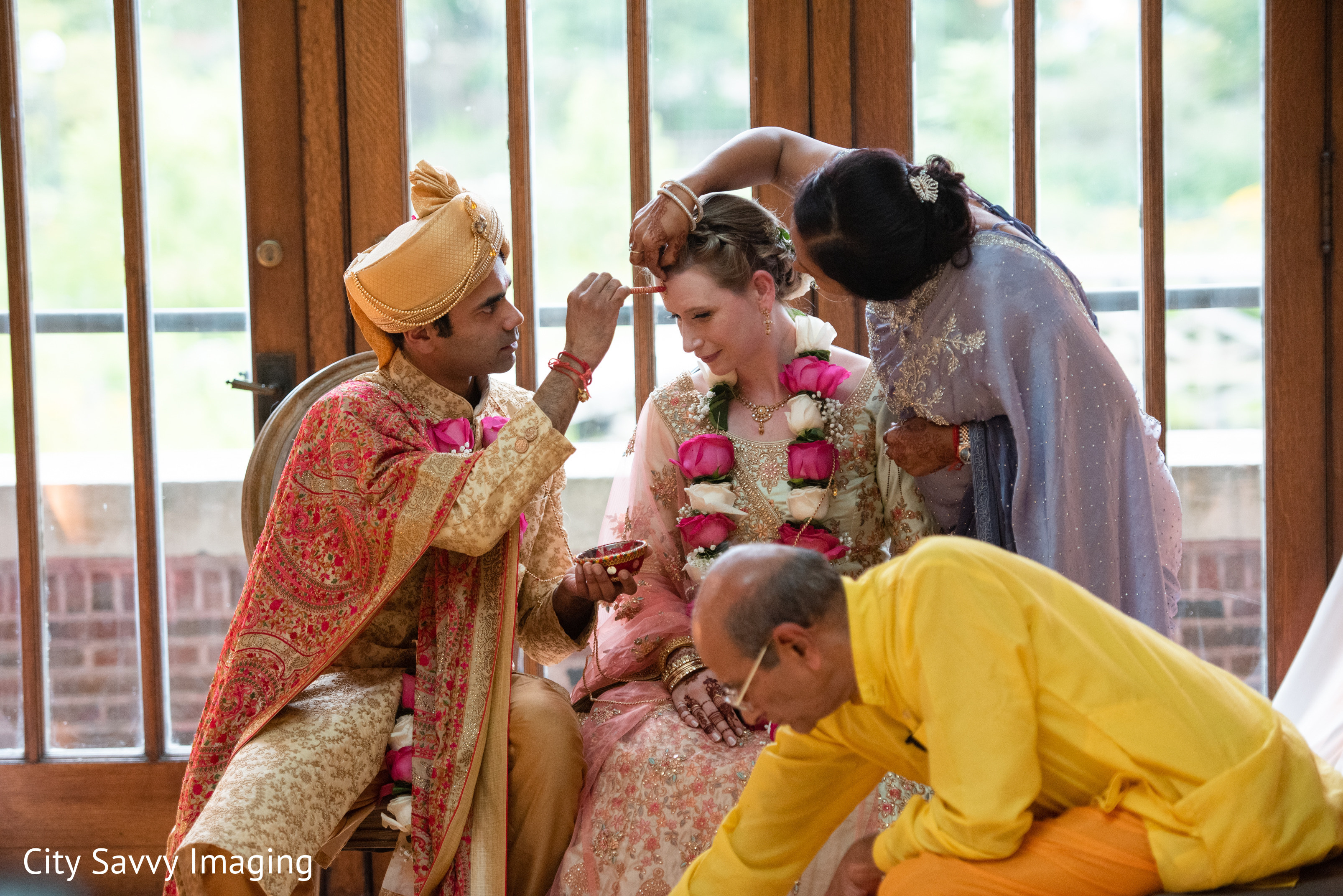 Indian groom putting the red mark on bride's forehead. | Photo 261539