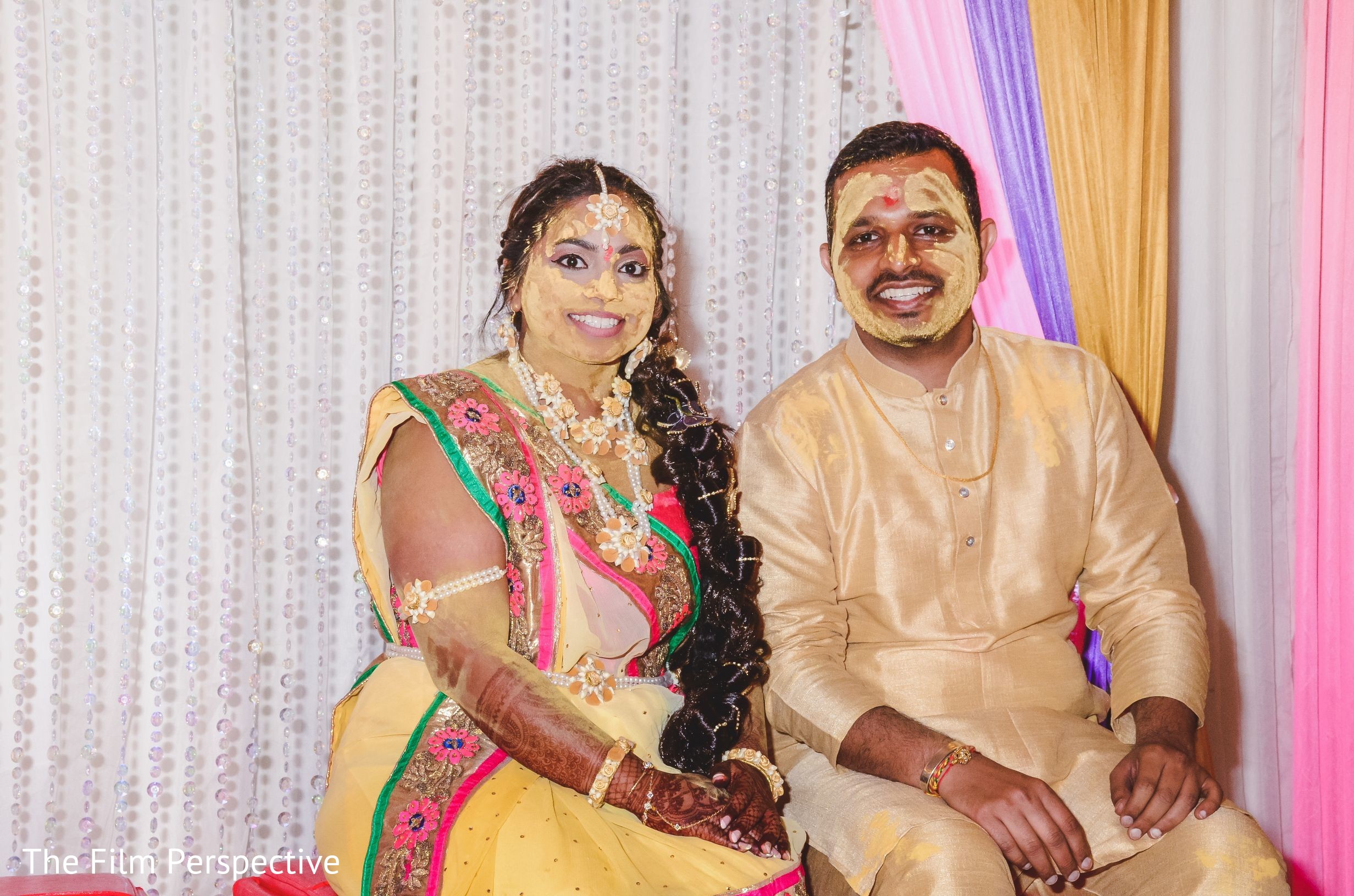 Indian bride and groom wearing turmeric paste during Haldi ceremony ...