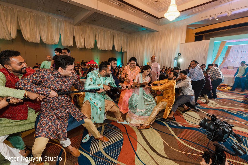 Indian couple and relatives playing tug of war | Photo 262939