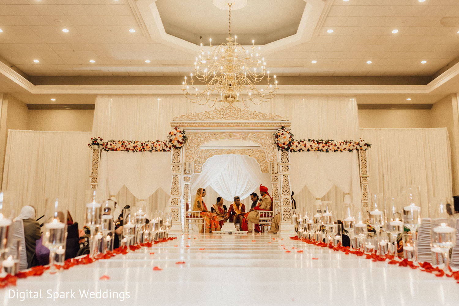 Indian groom and his Maharani sitting on the stage of the wedding hall ...