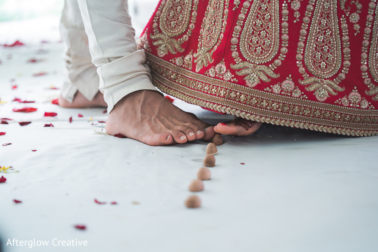 Indian couple when stepping on nuts with toes ritual. | Photo 265611