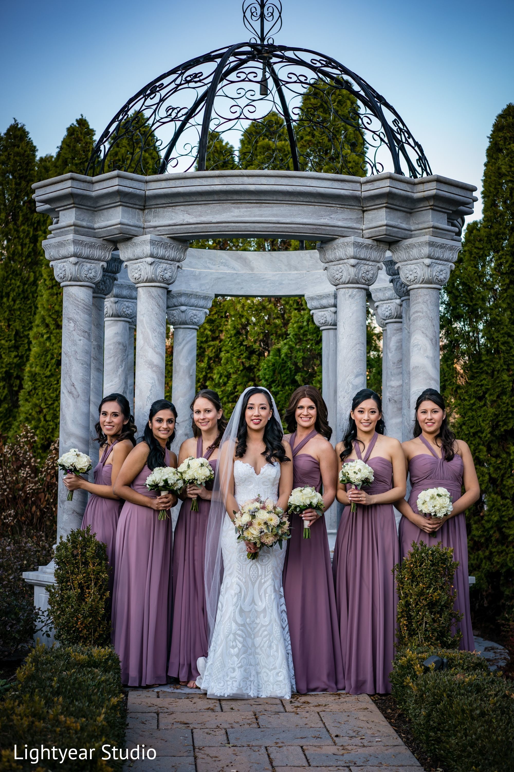 Indian bride with bridesmaids holding their ceremony bouquets. | Photo ...