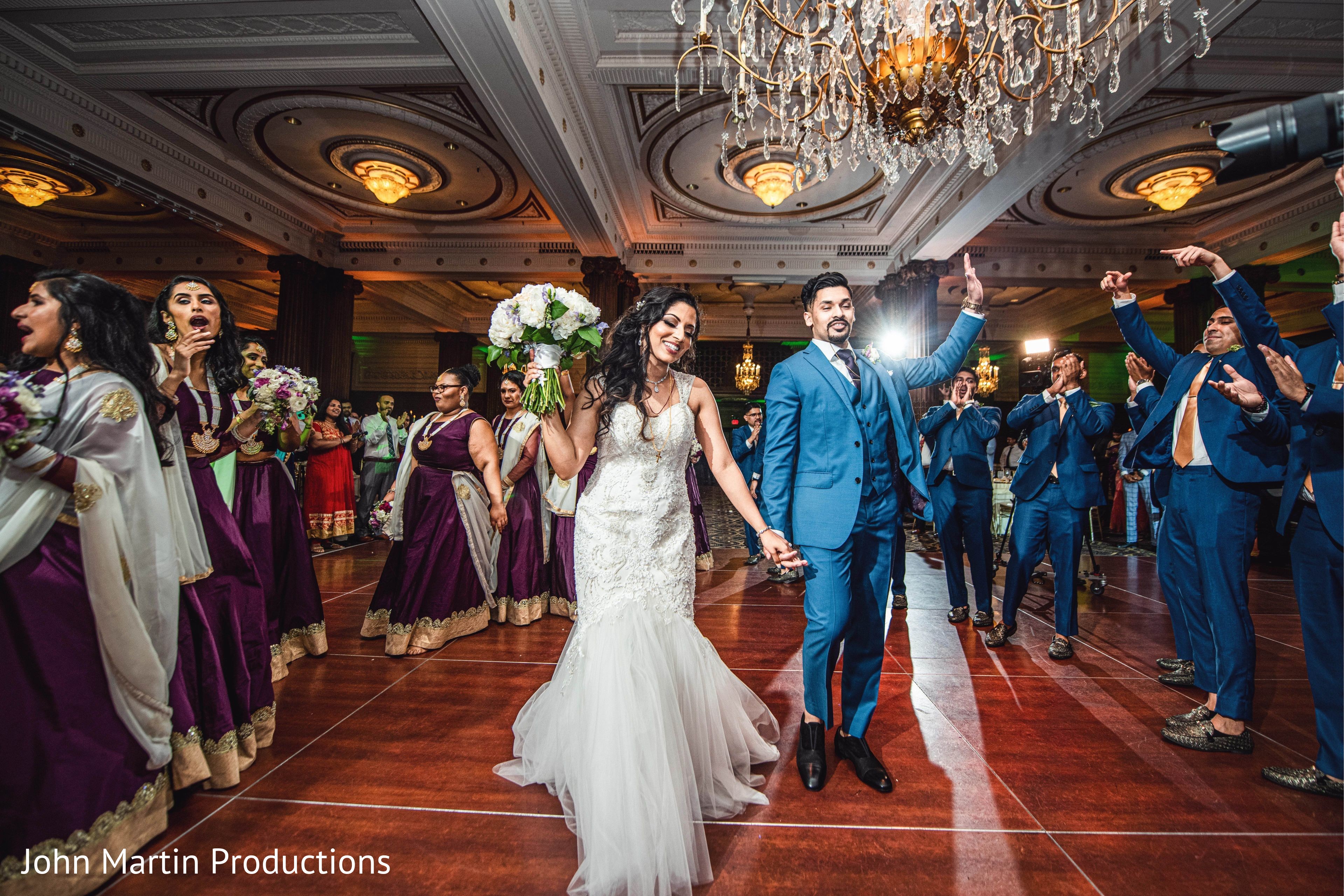 Indian bride and groom making their entrance to wedding reception ...