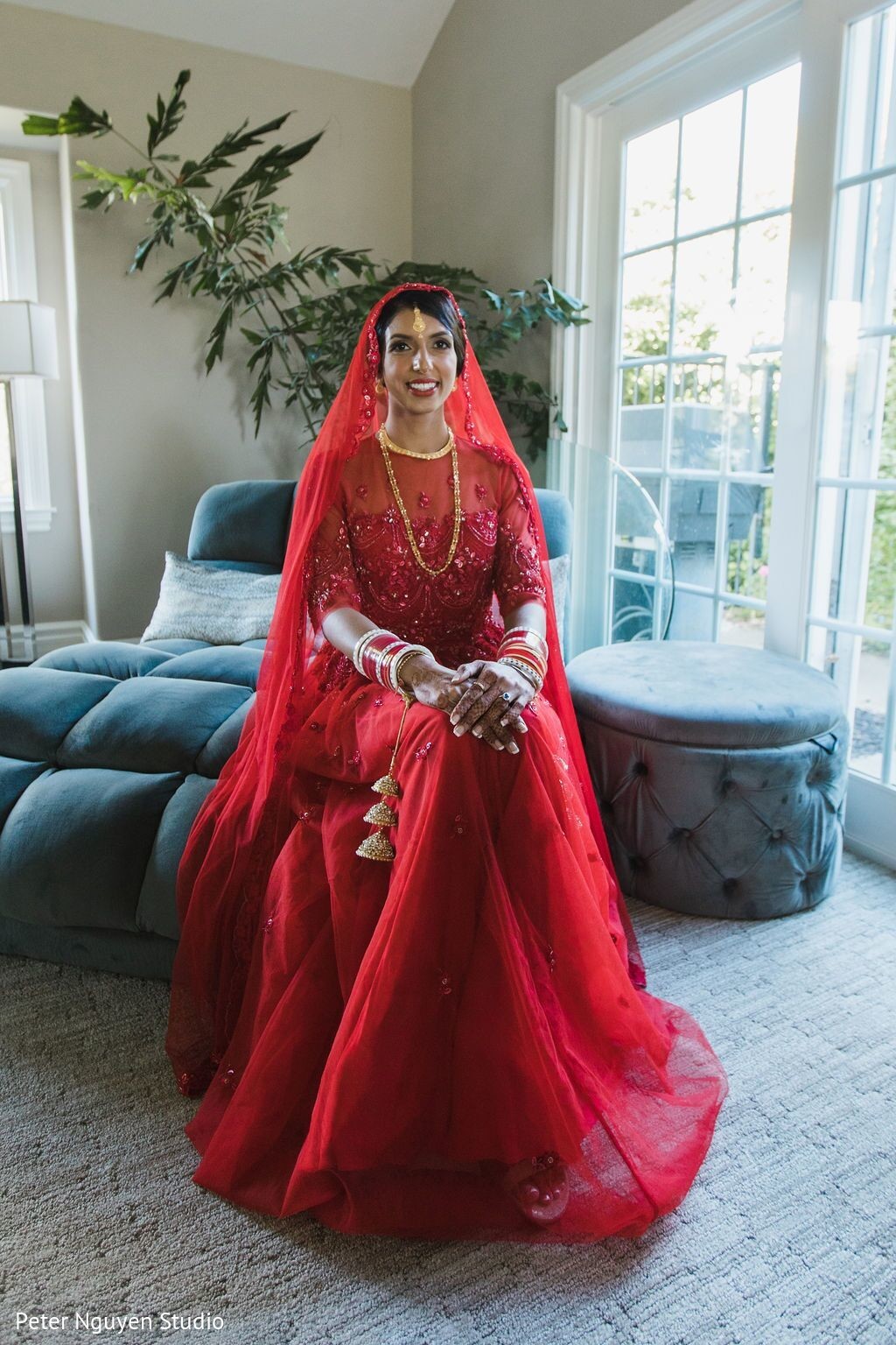 Indian bride waring her ceremony red dress and jewelry. | Photo 266670