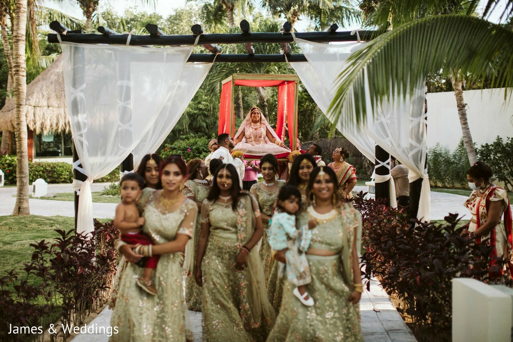 Indian bride making her entrance to the ceremony on Doli entrance ...