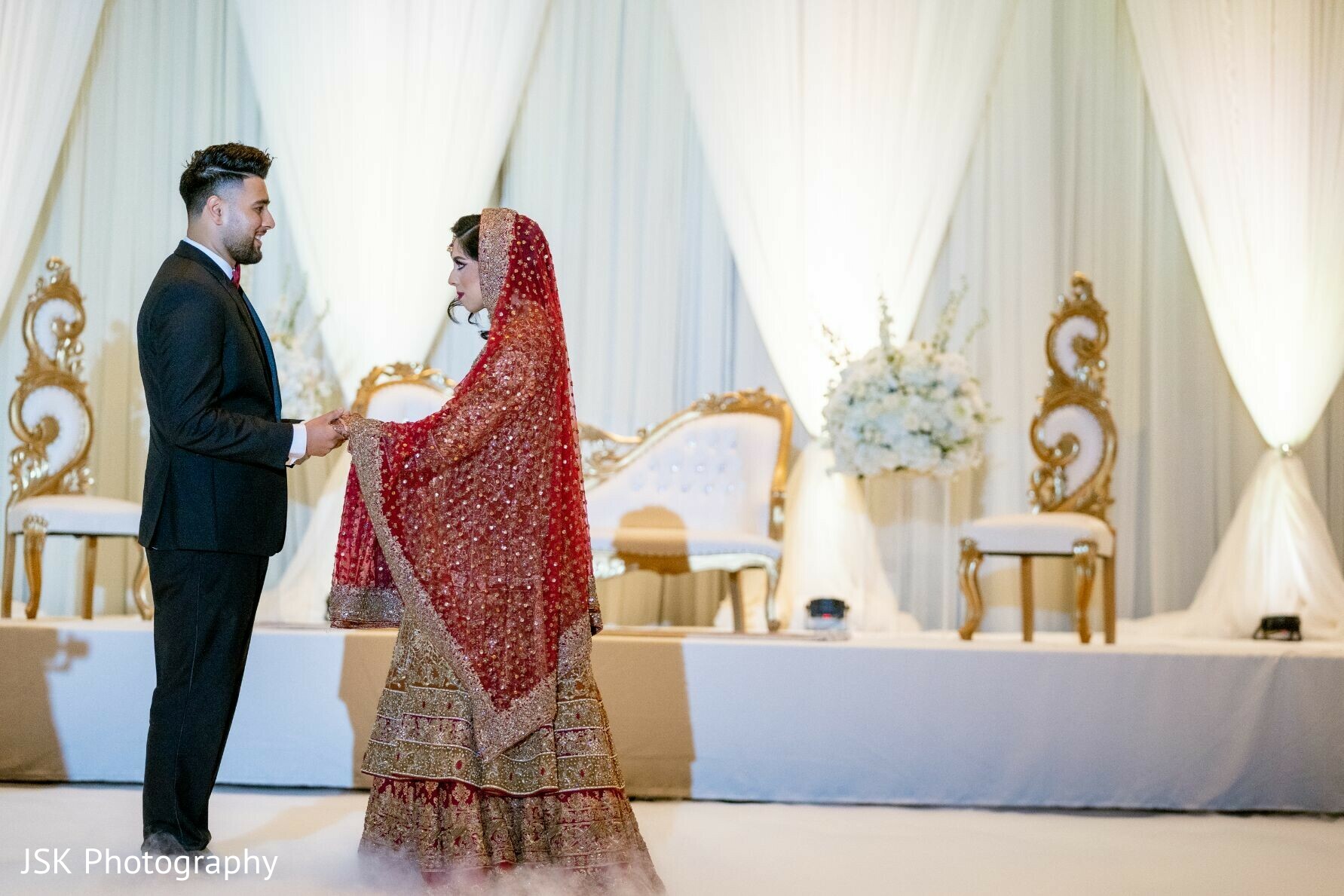 Joyful Indian bride and groom holding hands capture. | Photo 325499