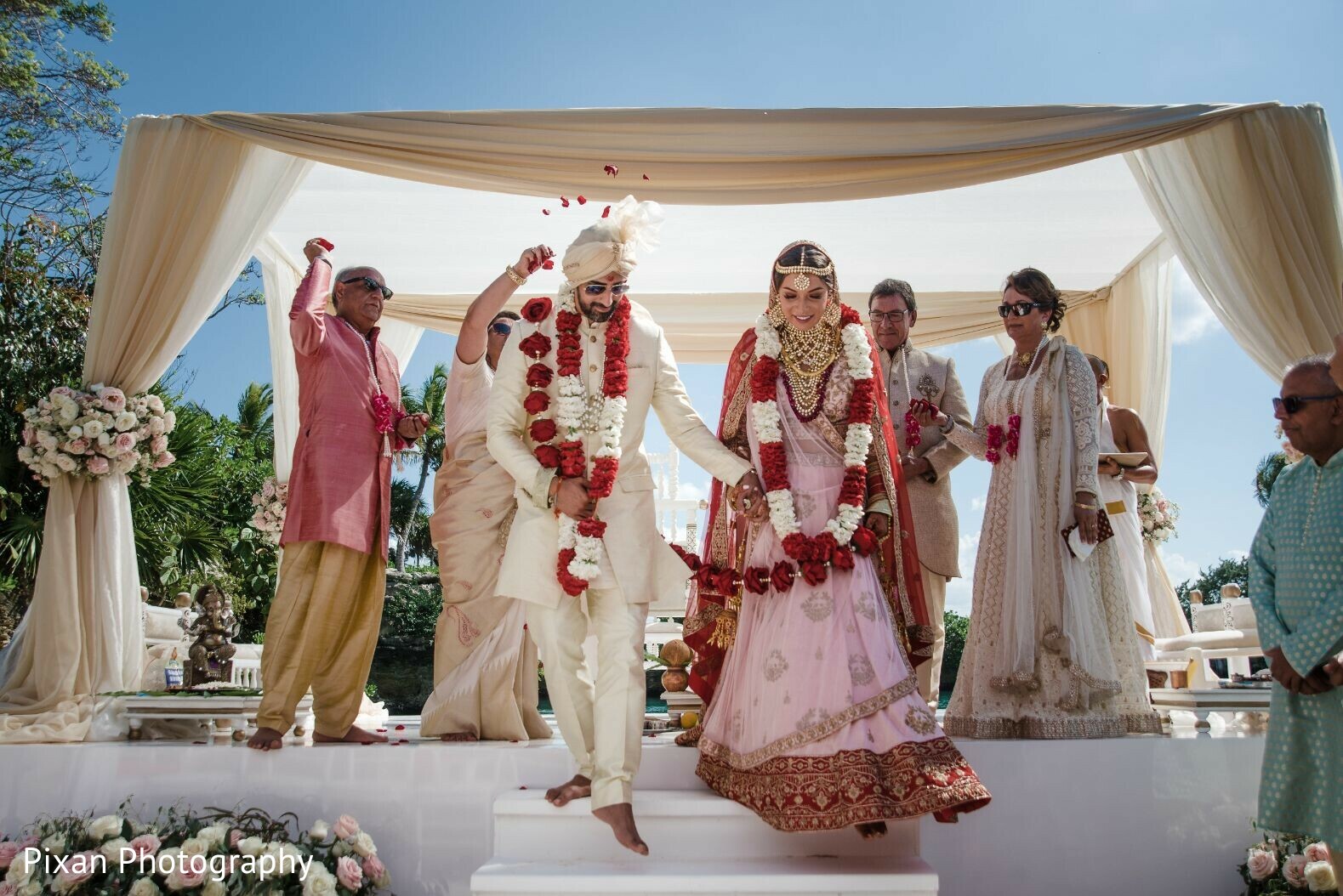 Joyful Indian bride and groom holding hands capture. | Photo 326461