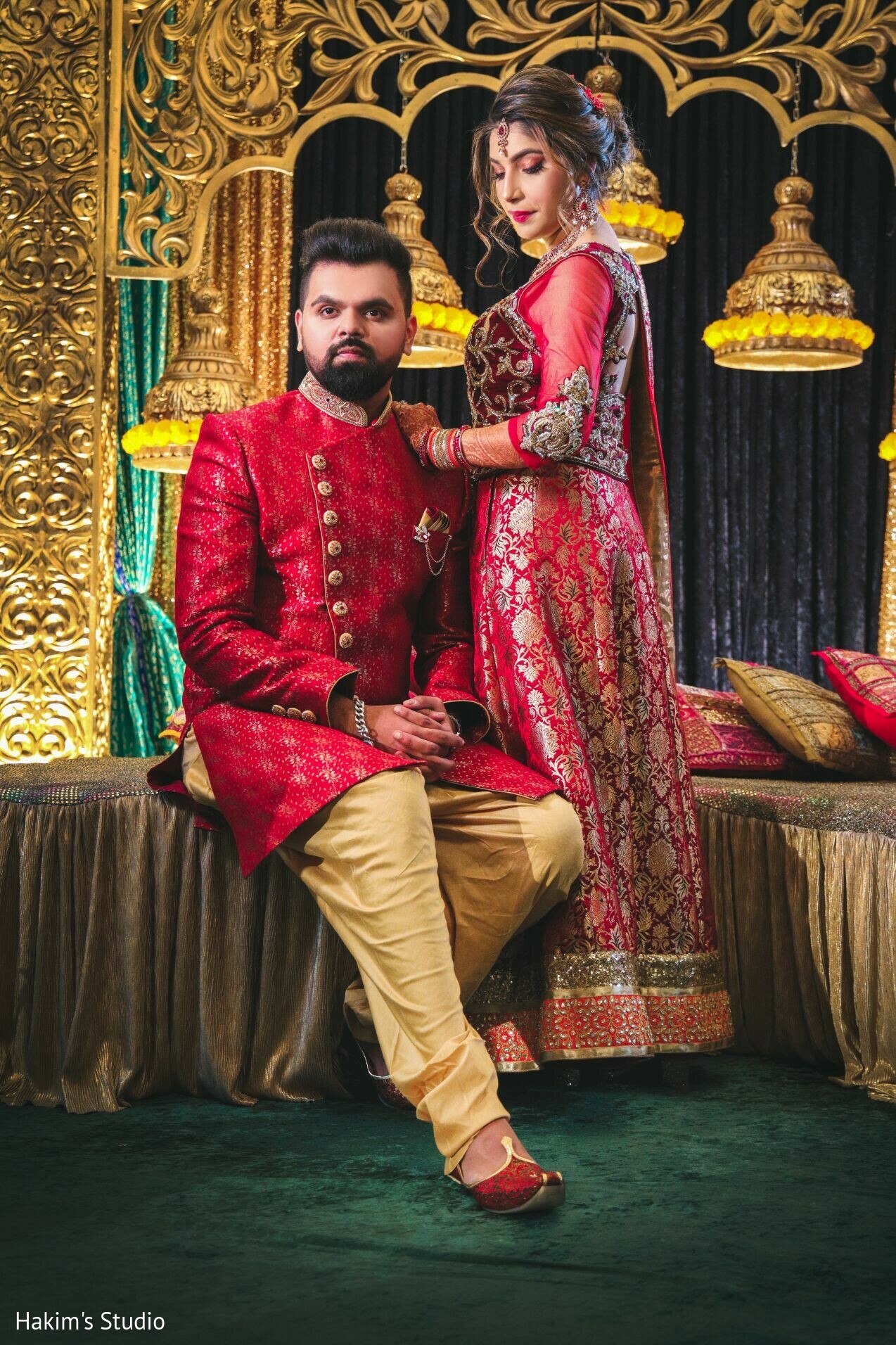 Lovely Indian bride and groom posing with their traditional outfits ...