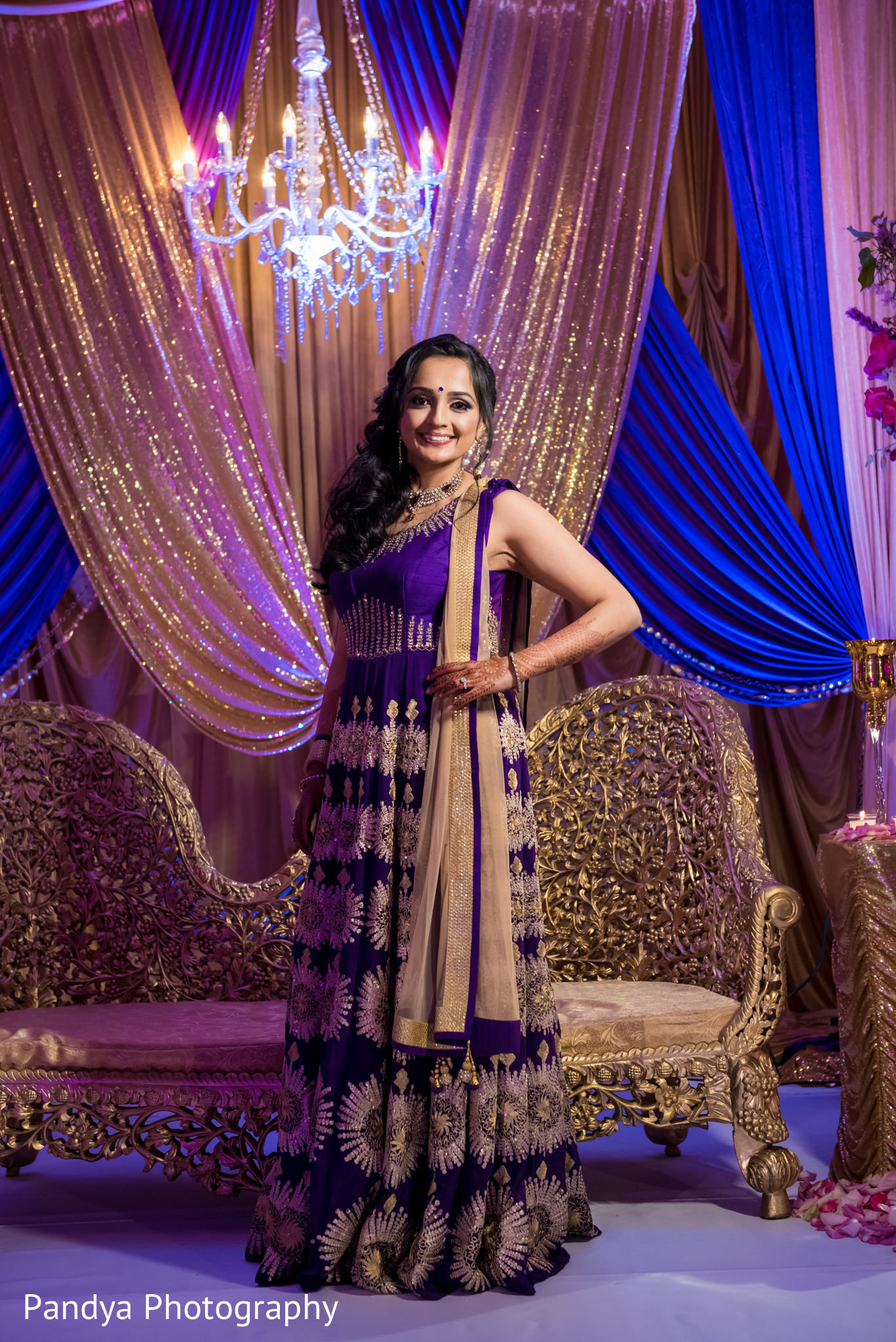 Indian bride wearing a purple an golden reception outfit. | Photo 90939